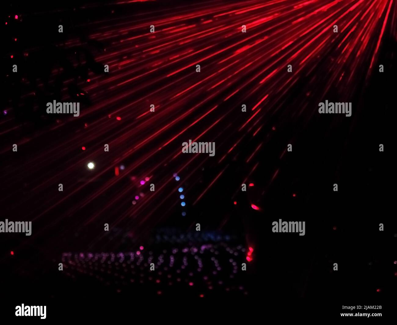 Bright red beams illuminate dark space with bright glowing lights ...
