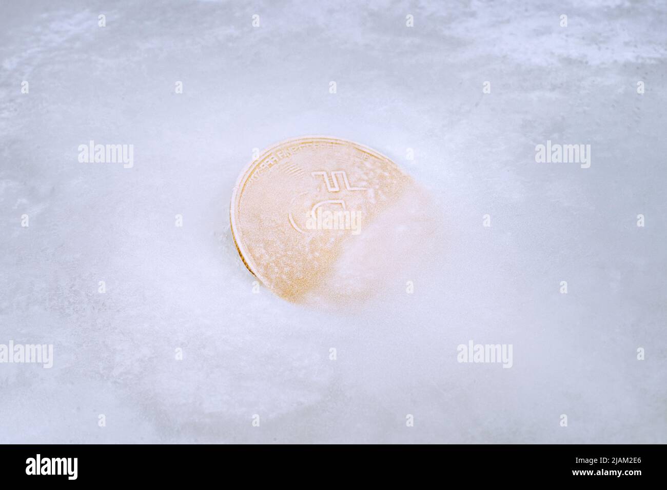 Frosted golden coin with bitcoin symbol frozen in ice. Freezing of ...