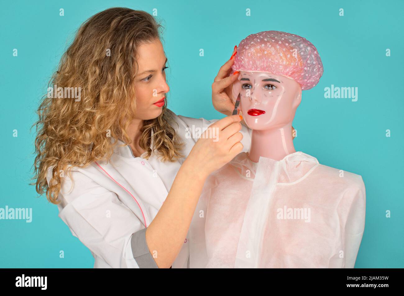 glamorous doctor makes plastic surgery on the face of a mannequin ...