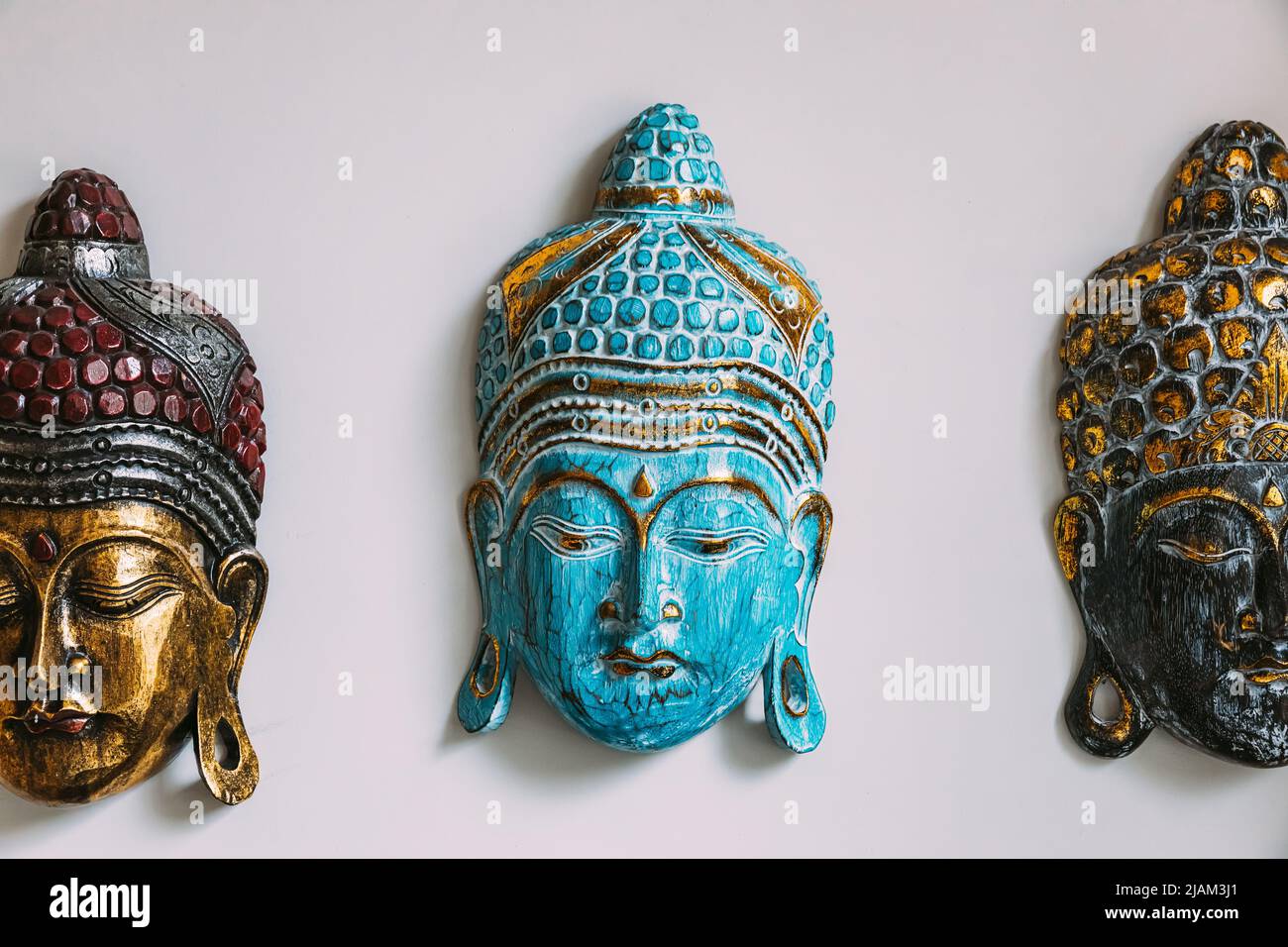 Close up of handmade souvenirs buddha mask on white background ...