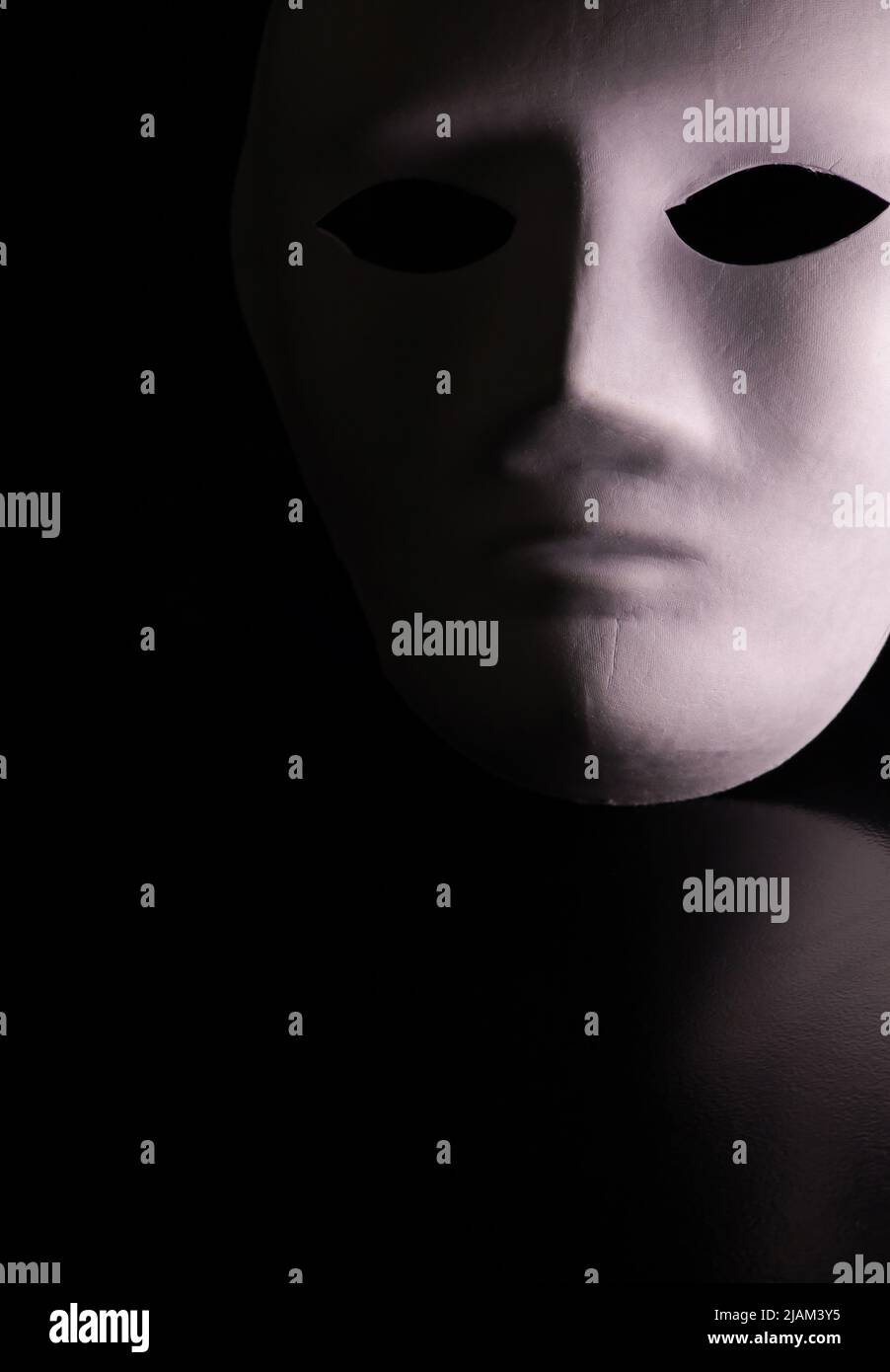 white mask isolated on black background Stock Photo - Alamy
