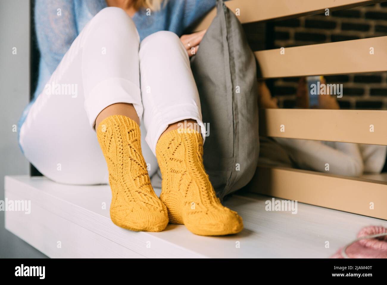 Comforting cozy woman in knitted woolen winter yellow socks, white ...