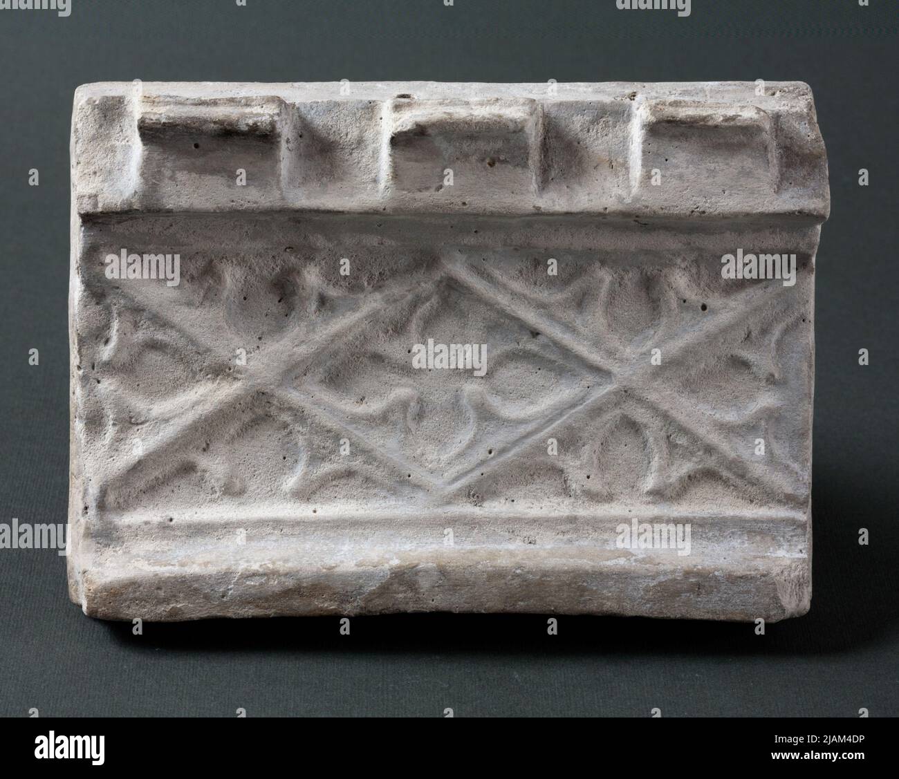 A tile decorated with a frieze with rhombras, within which four legged ...