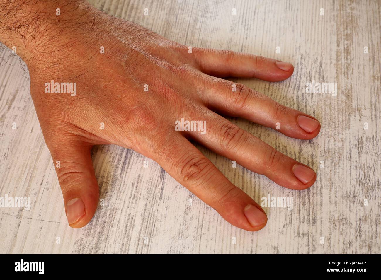 a man's hand on the table Stock Photo - Alamy