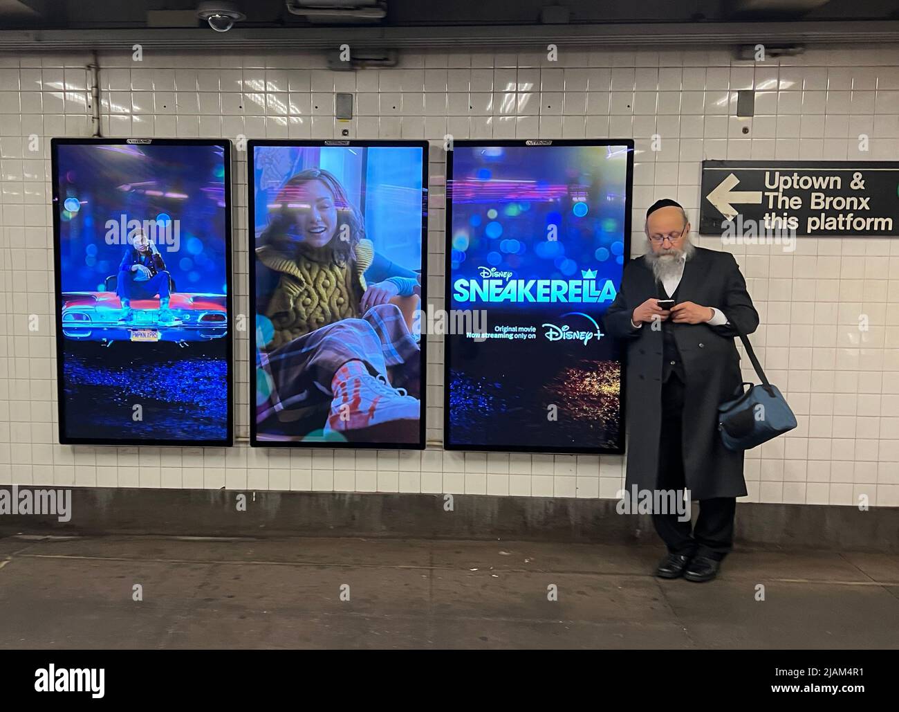 Orthodox Jewish man on his phone while waiting for a Lexington Line 6 ...