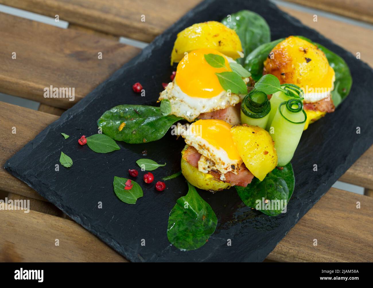 Close up of mini burgers from quail eggs with baked potatoes at plate ...