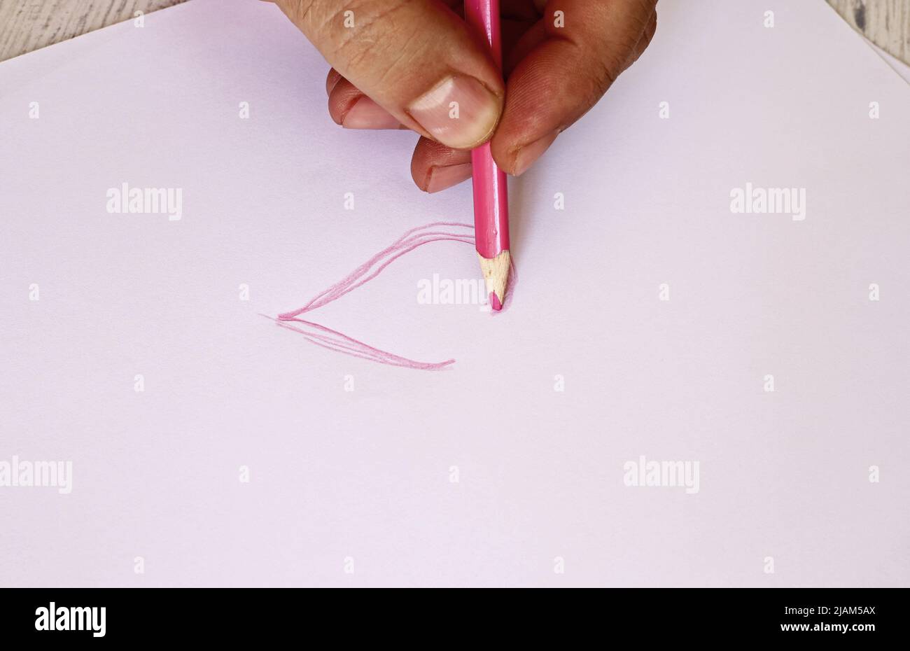 hand drawing heart on paper Stock Photo - Alamy