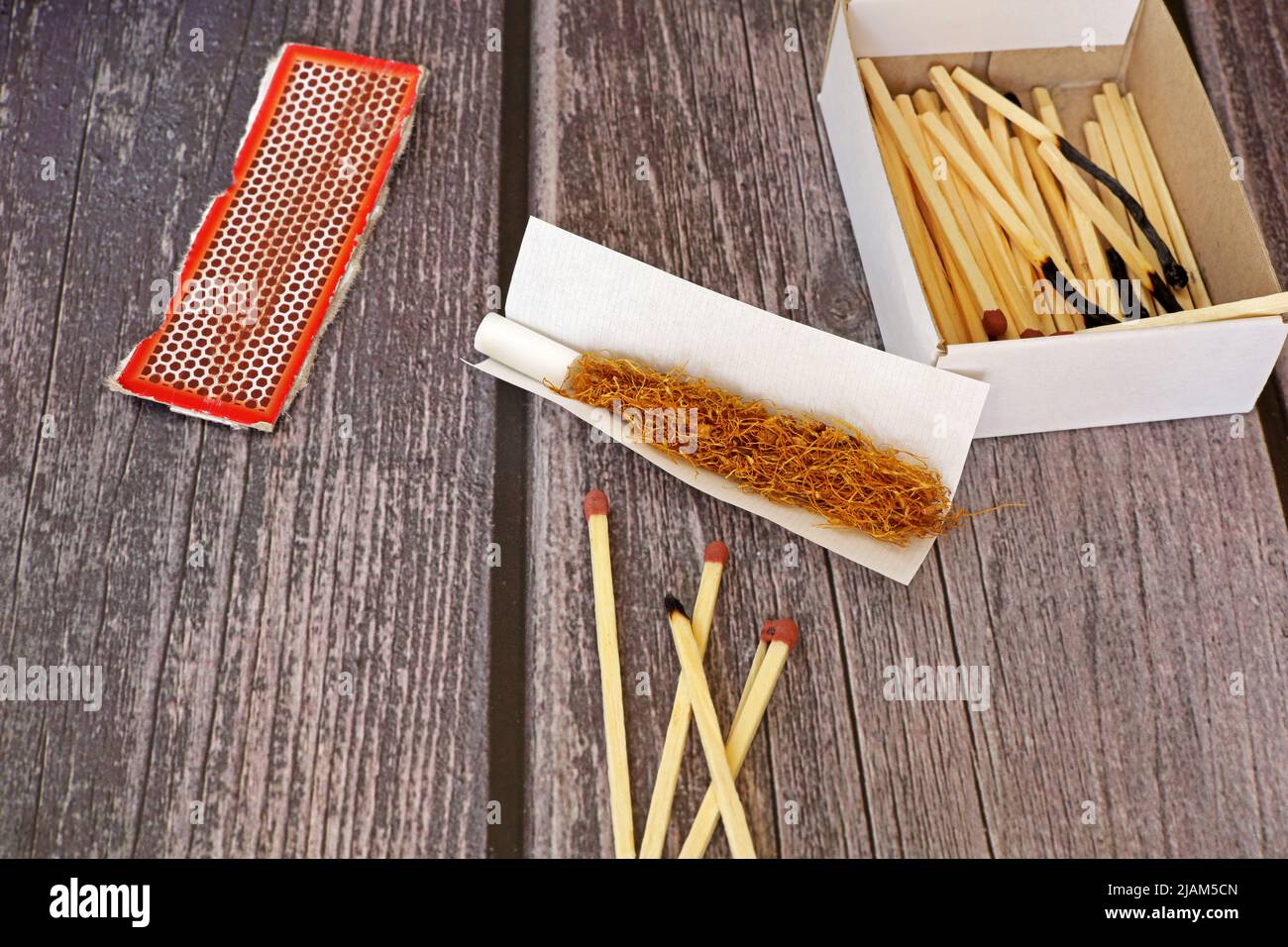 rolling cigarette with matchstick on the table Stock Photo - Alamy
