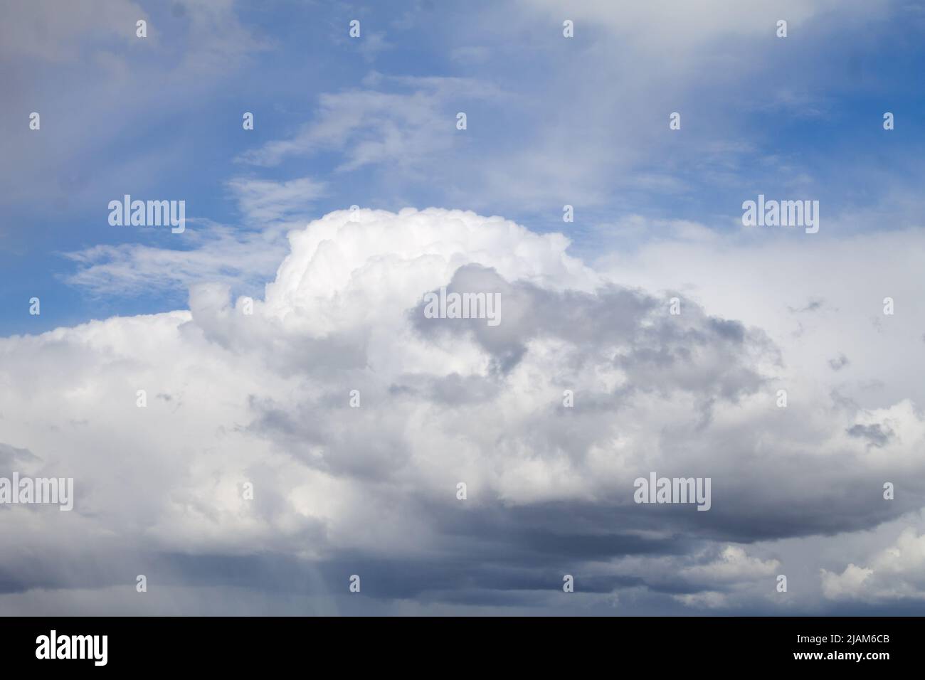 Low gray and gray-white rain clouds. Blue sky with cumulonimbus clouds ...