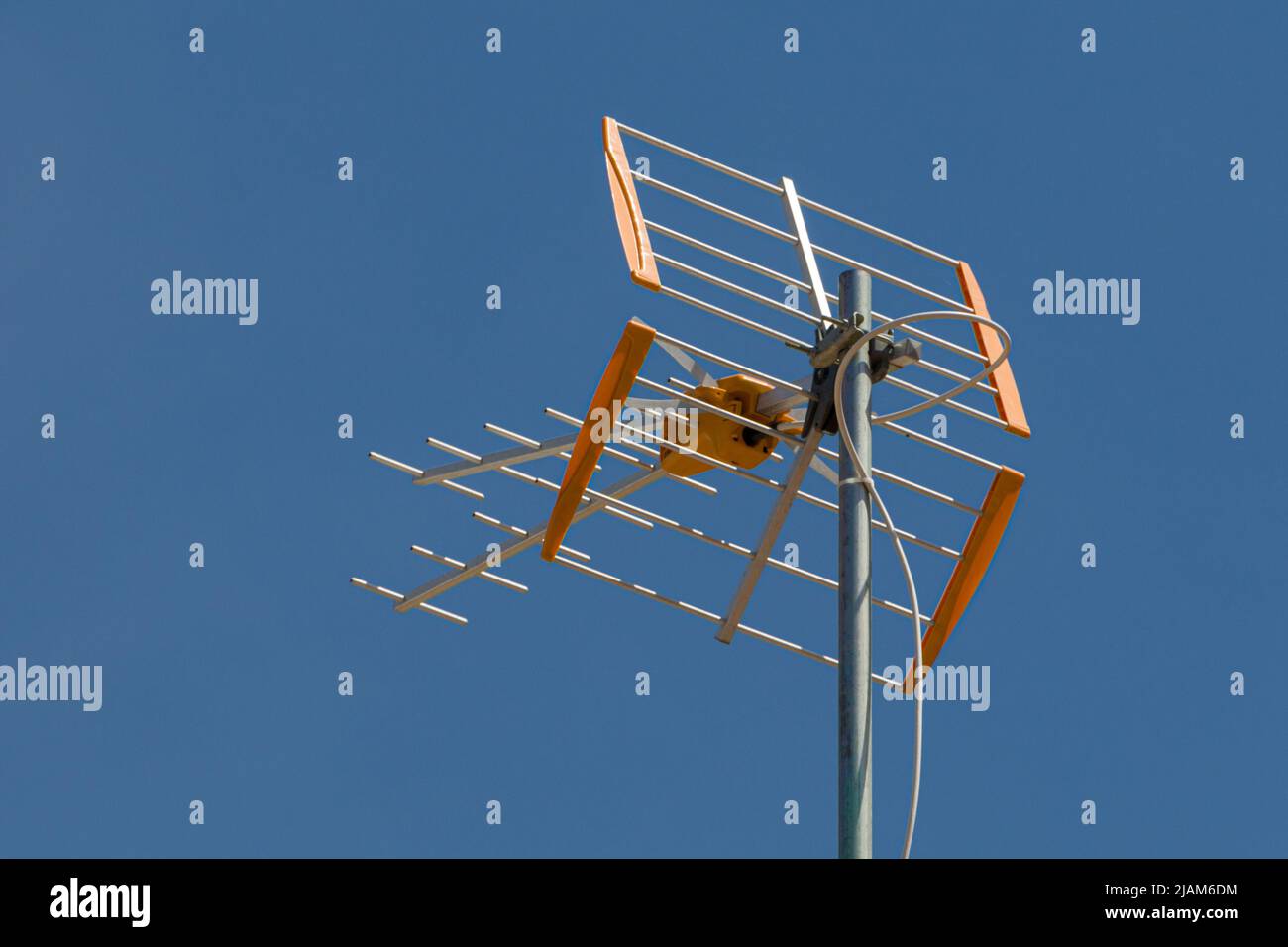 television antenna on a rooftop in front of a blue sky Stock Photo - Alamy