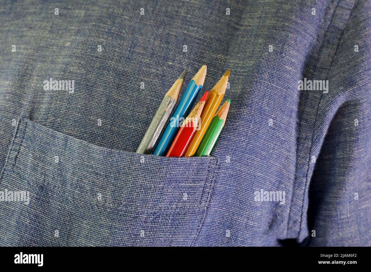 colored pencils in a shirt pocket Stock Photo - Alamy