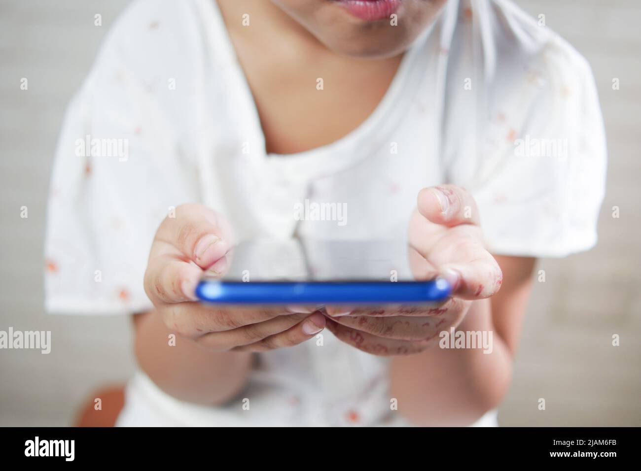 child hand pointing finger on smart phone screen Stock Photo - Alamy
