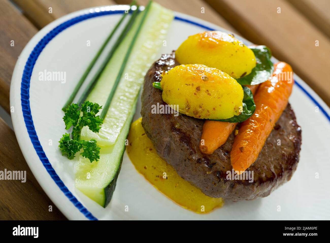 Beef patty with baked vegetables Stock Photo - Alamy