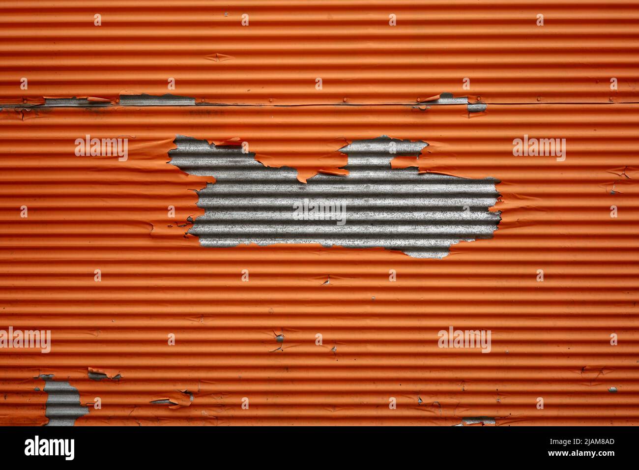 old orange iron shop shutter background Stock Photo - Alamy