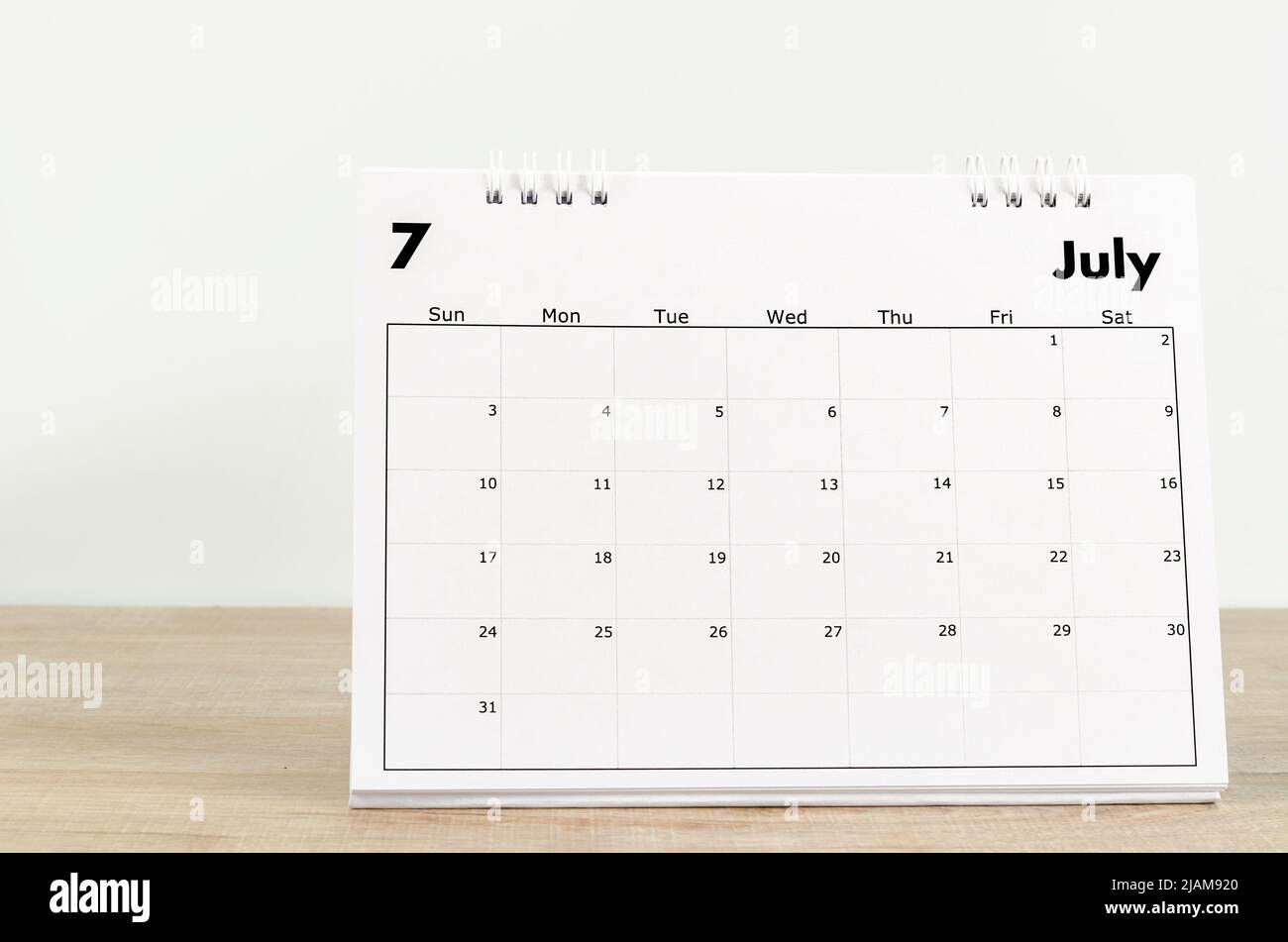The July 2022 desk calendar with plant on wooden table Stock Photo - Alamy