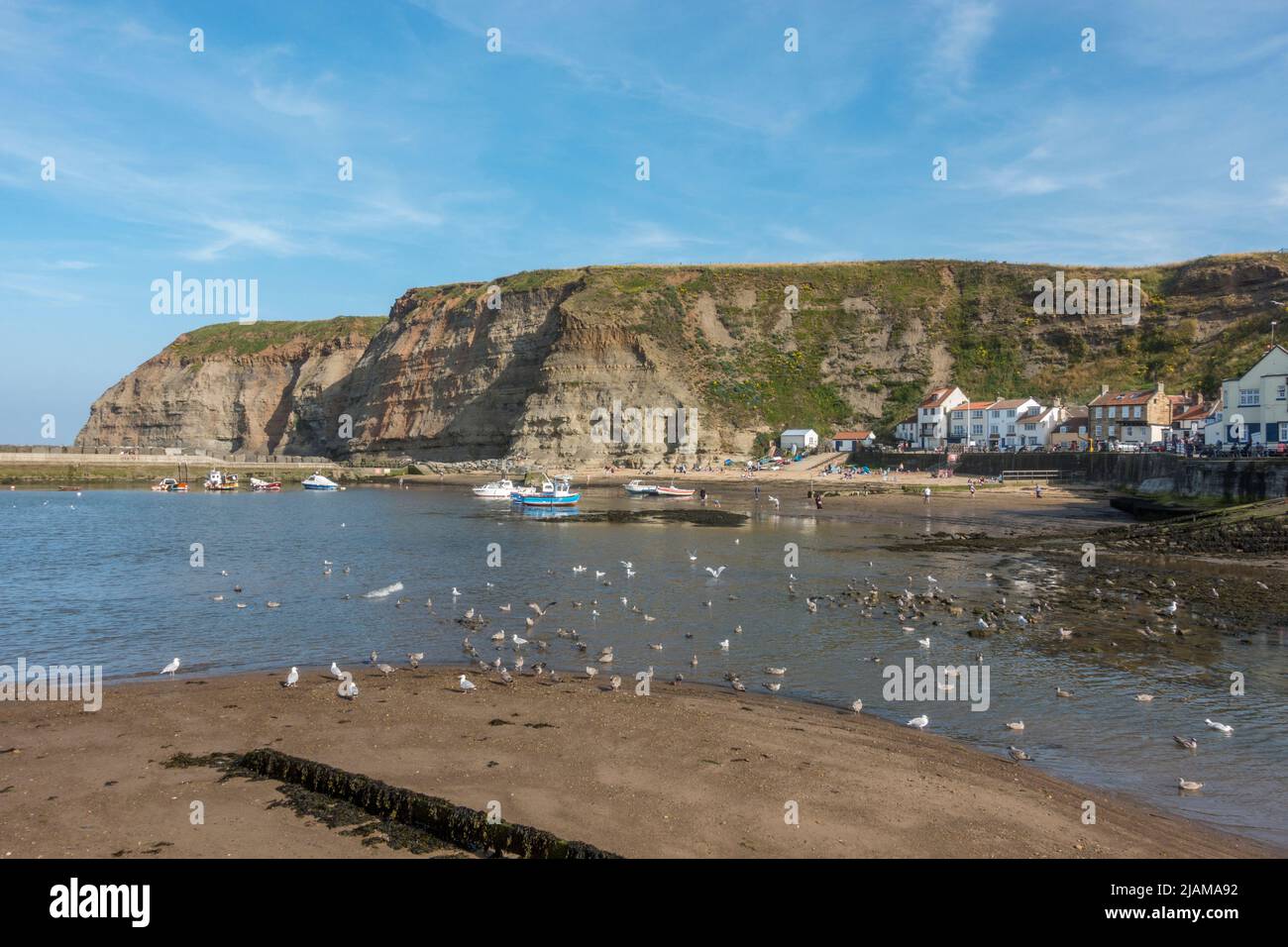 The beach and small harbour at Staithes, North Yorkshire, UK Stock ...