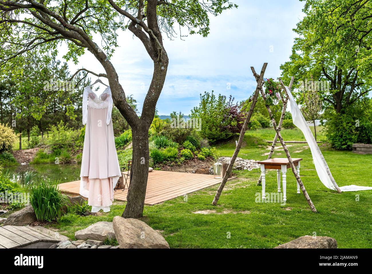 wedding dress of the bride in the garden Stock Photo - Alamy