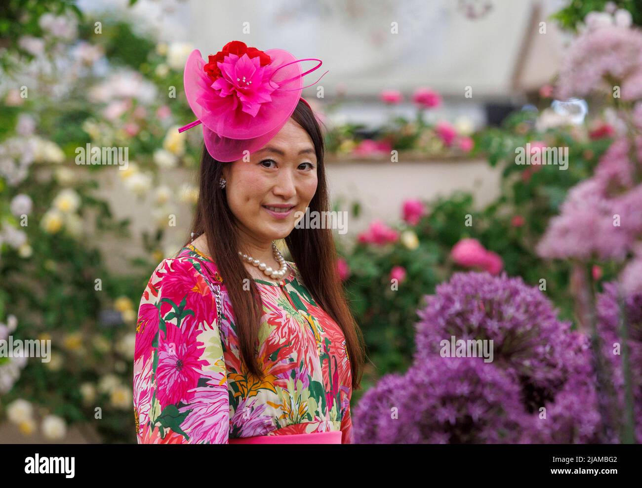 A fashionable Lady with a pink hat visits the RHS Chelsea Flower Show ...