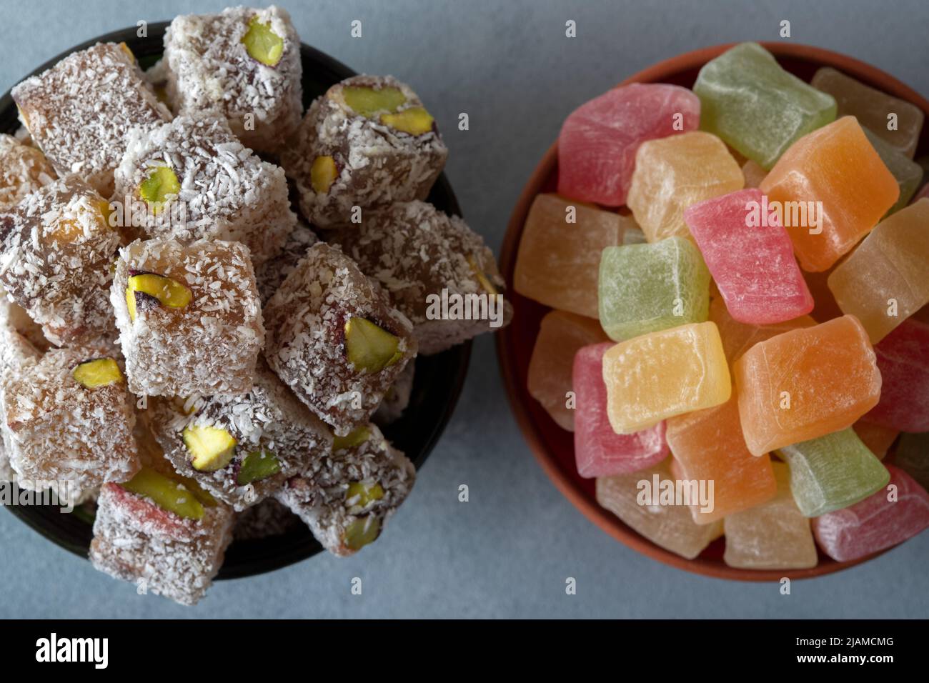 Traditional Turkish delight in two bowls.Pistachio and multicolored ...