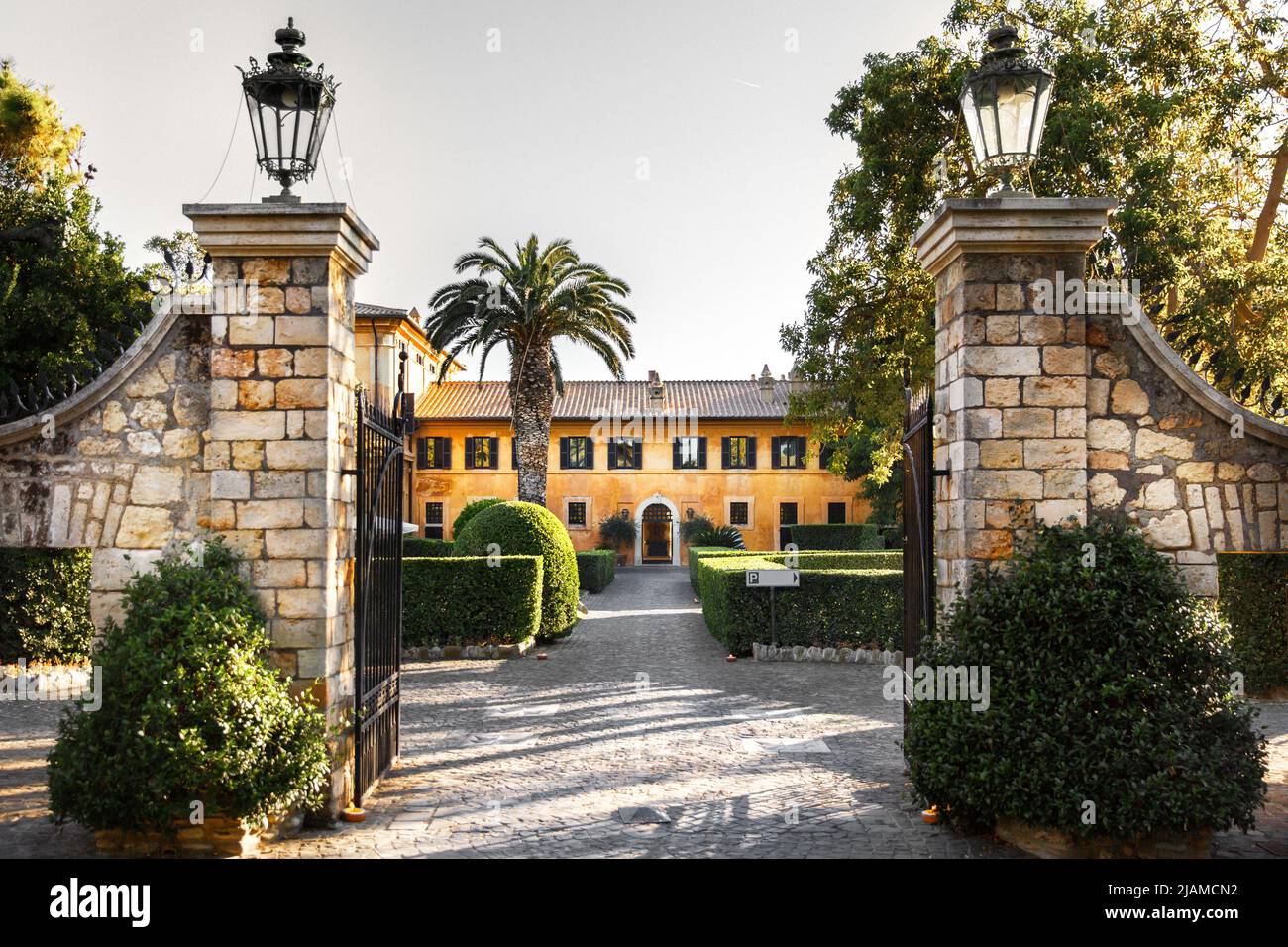 View through the gate to the Italian villa Stock Photo - Alamy