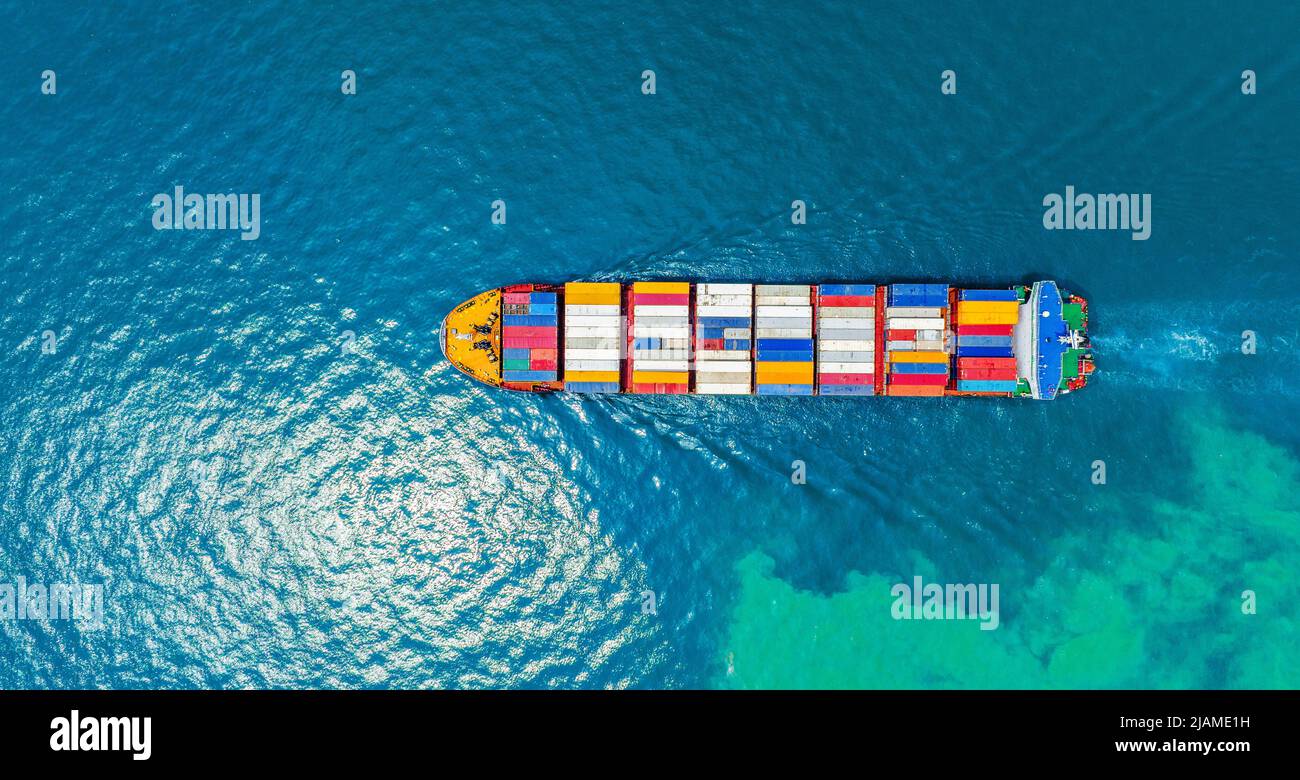 Aerial top view of cargo ship carrying container and running for export ...
