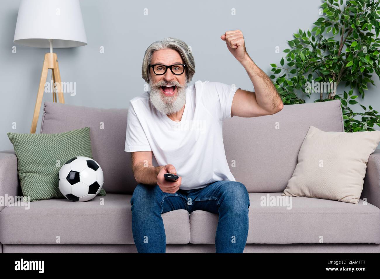Photo of lucky funky retired man wear white t-shirt glasses sitting ...