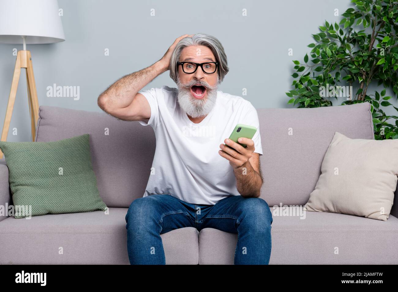 Photo of impressed shocked man pensioner dressed white t-shirt ...