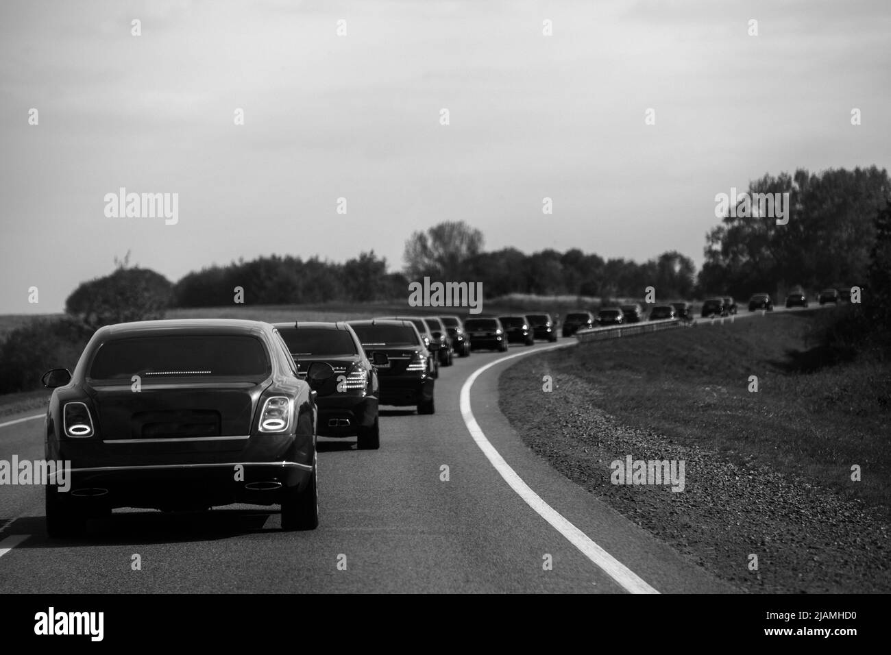 Row of black cars on the road. Wedding procession Stock Photo - Alamy