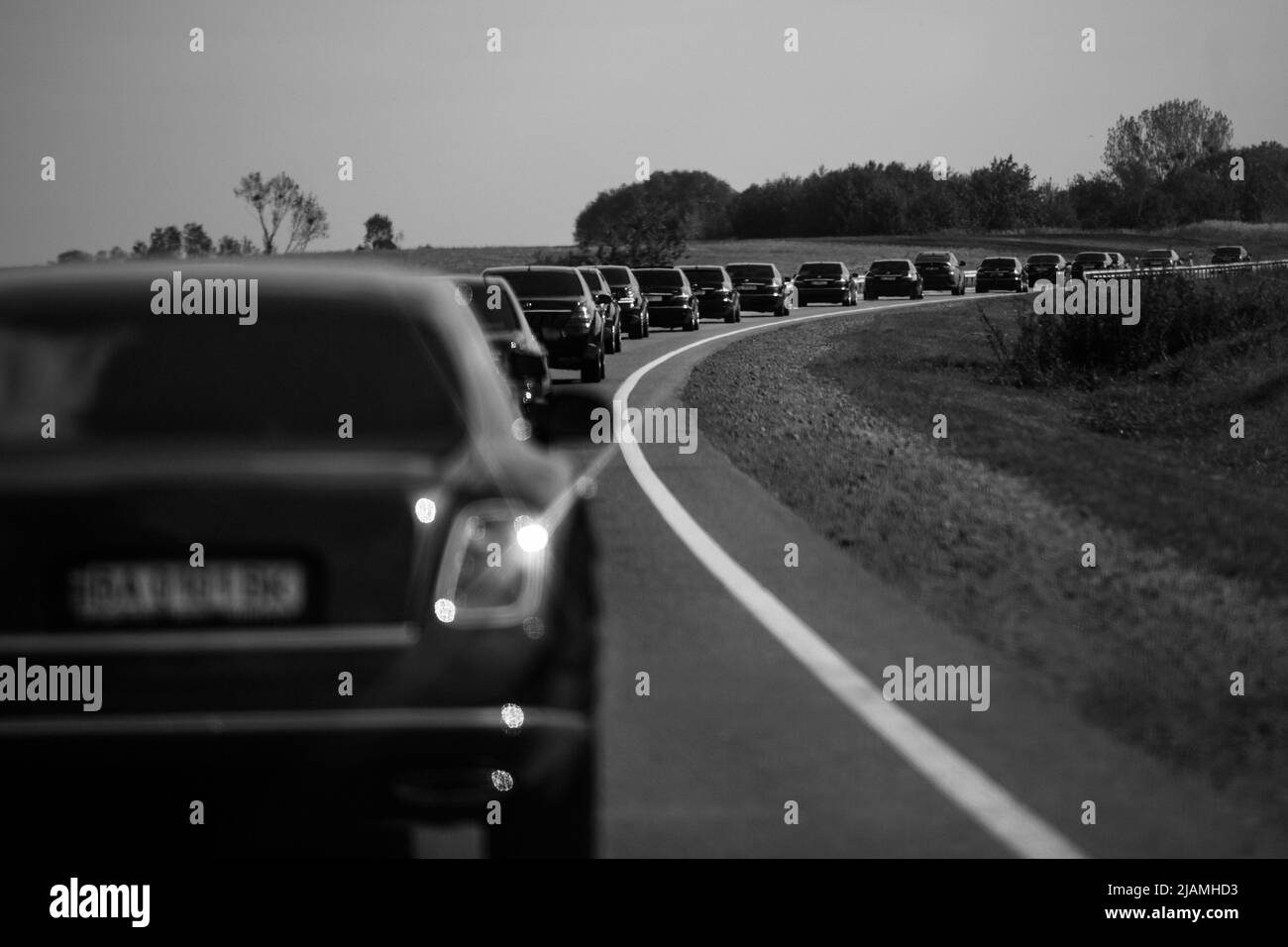 Row of black cars on the road. Wedding procession Stock Photo - Alamy