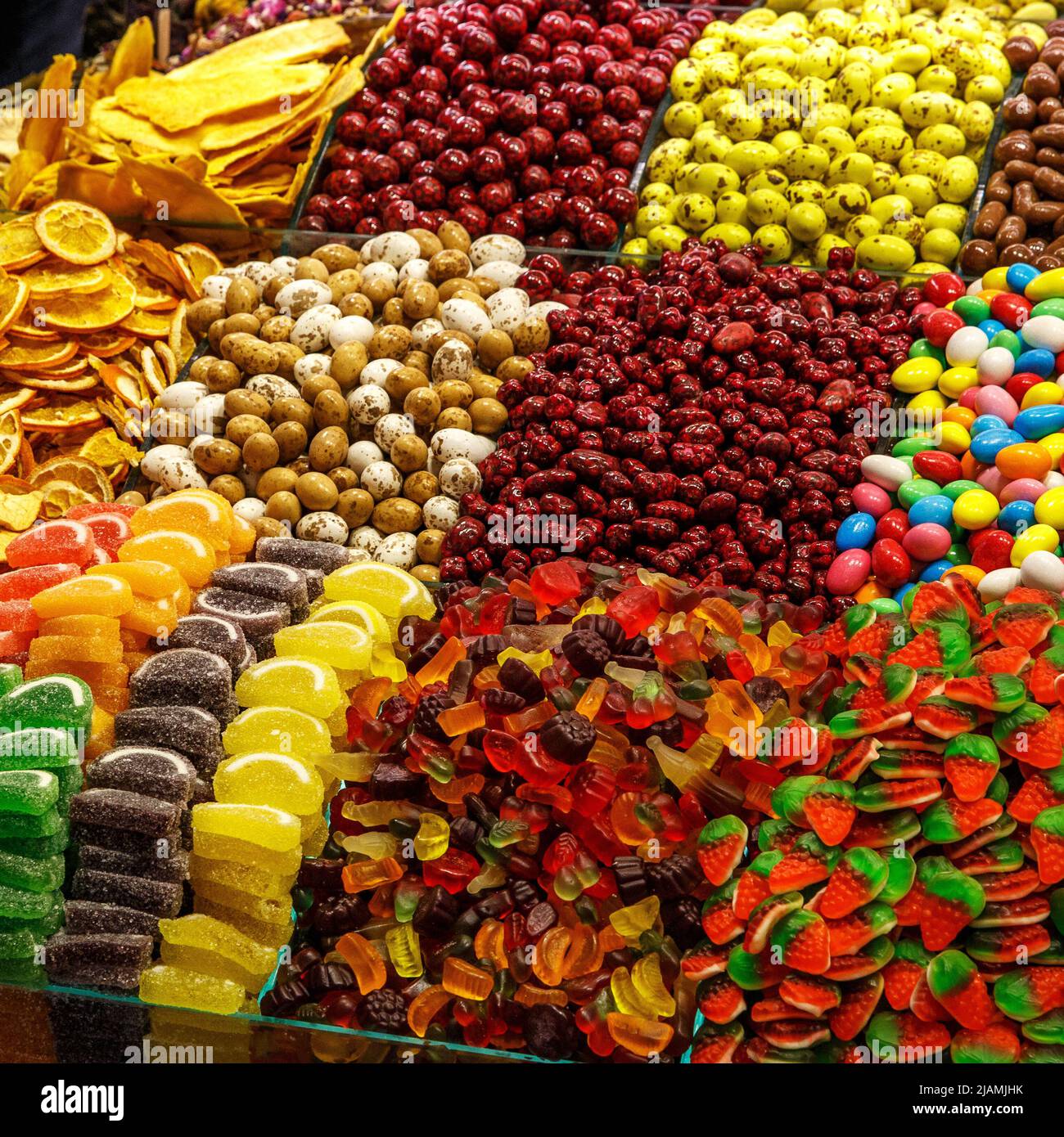 Close-up of colorful sweets and jellies at a market stall.Various ...