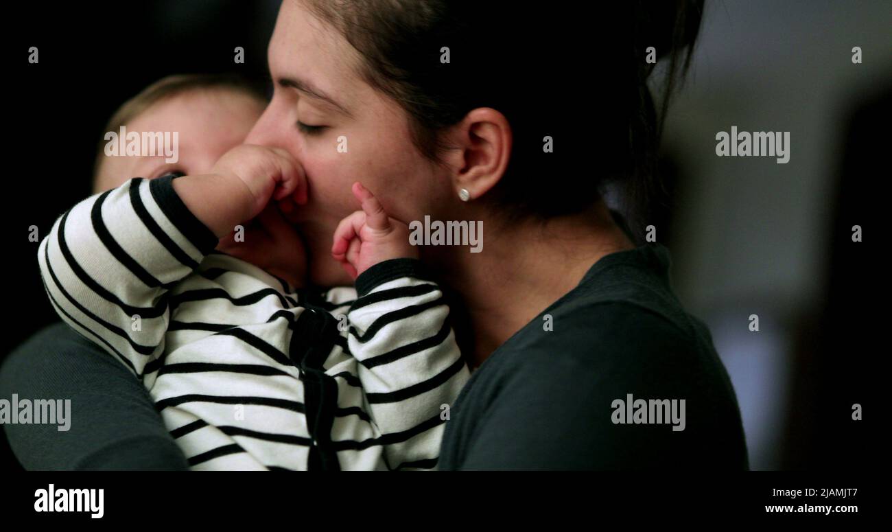 Casual mother kissing baby. Real life authentic loving caring parent ...