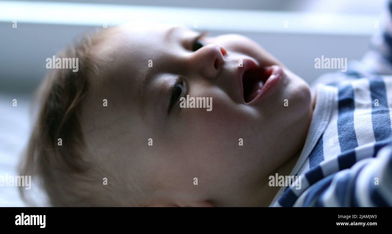 Contemplative baby thinking, infant toddler close-up face. Pensive ...