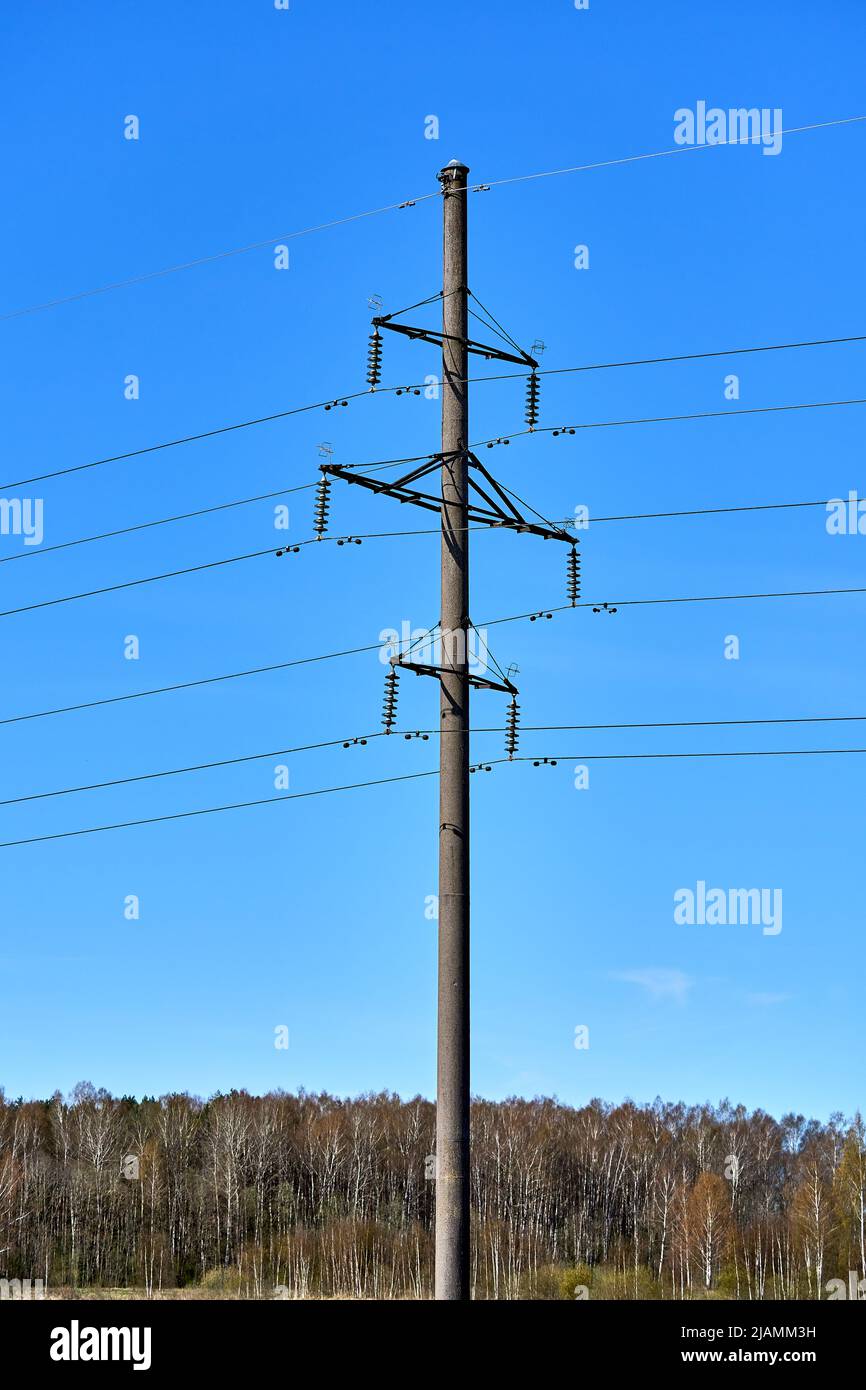 An old wooden electric pole power lines and wires with blue sky ...