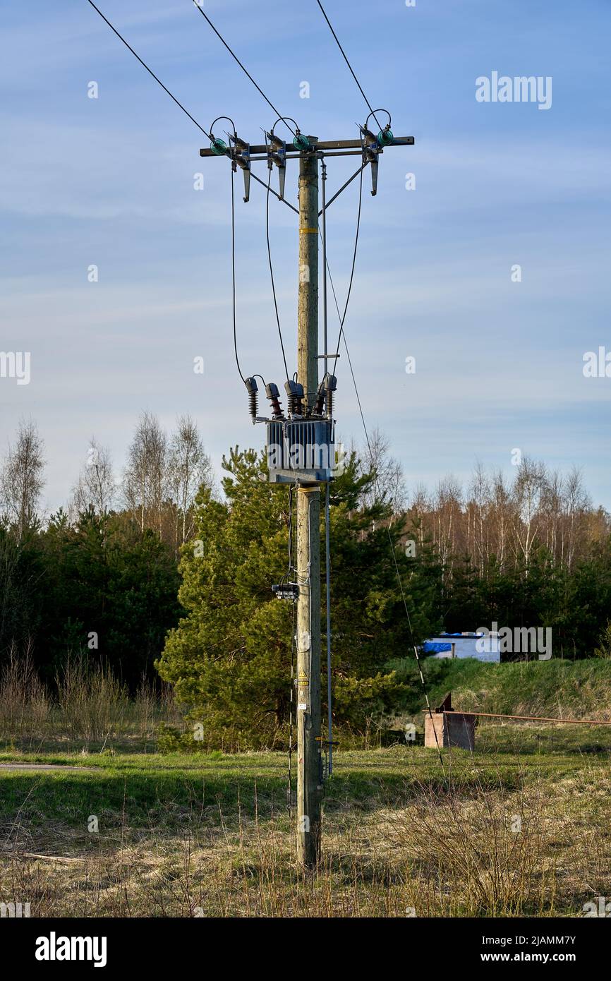 An old wooden electric pole power lines and wires with blue sky ...