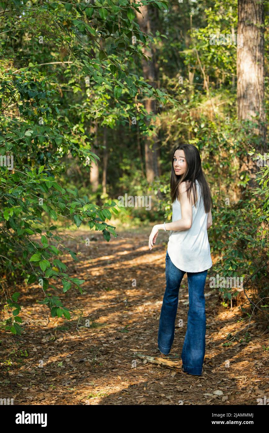 a beautiful teen girl on a nature walk in the sunny outdoors in the ...