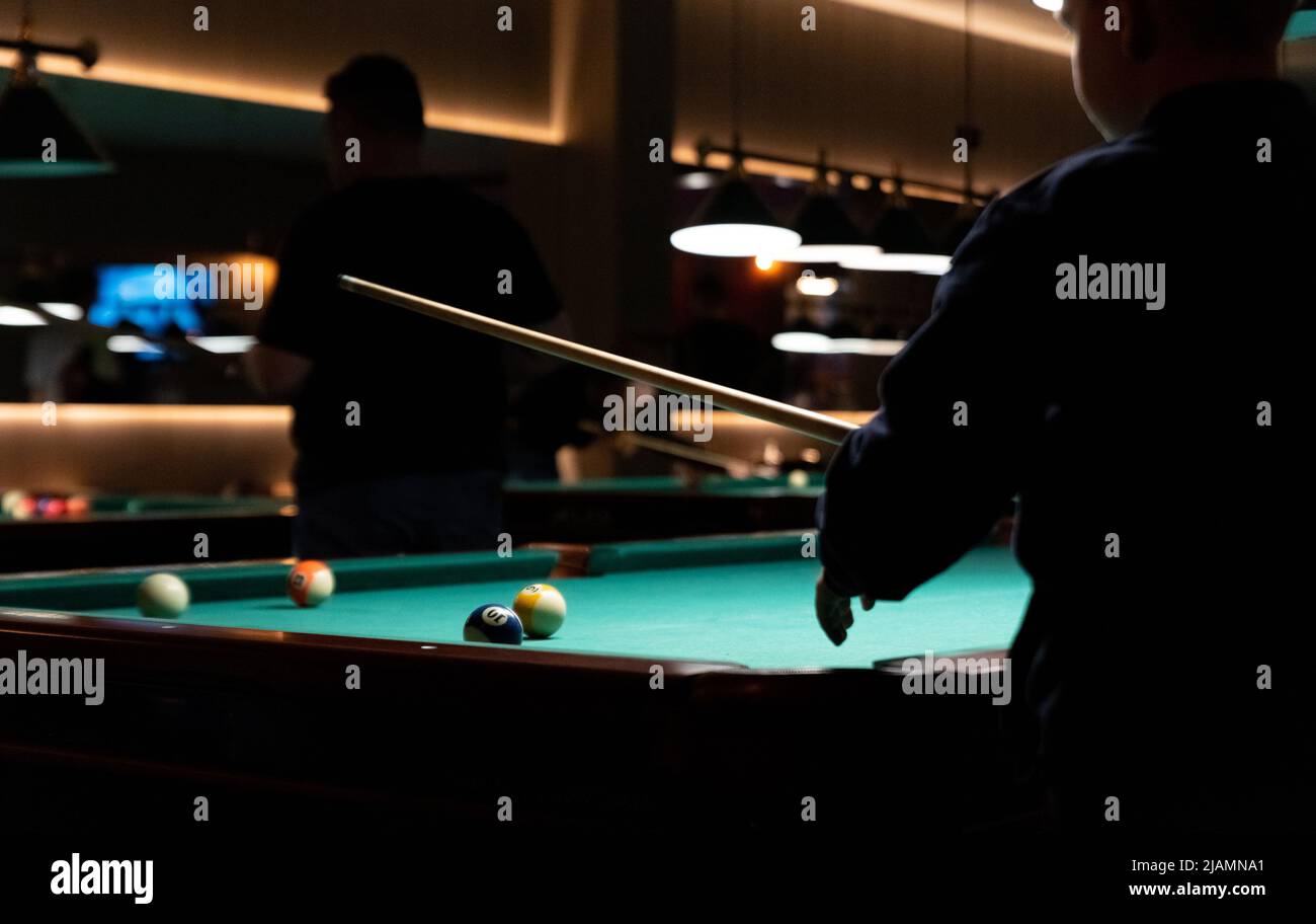 Pool tables for party games. Spending free time. A dark, atmospheric ...