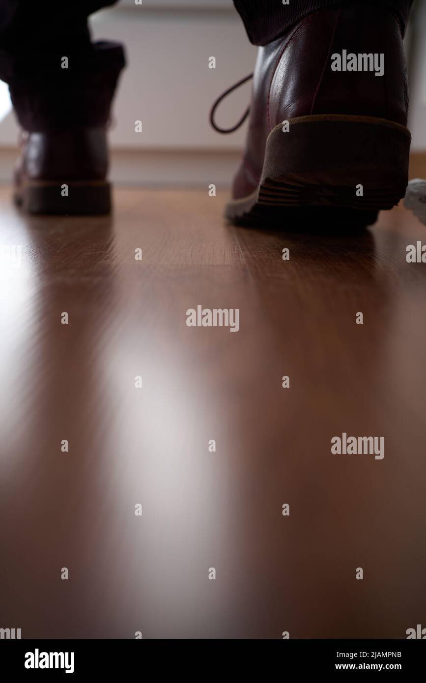 View from behind shoes taking a step away and copyspace Stock Photo - Alamy