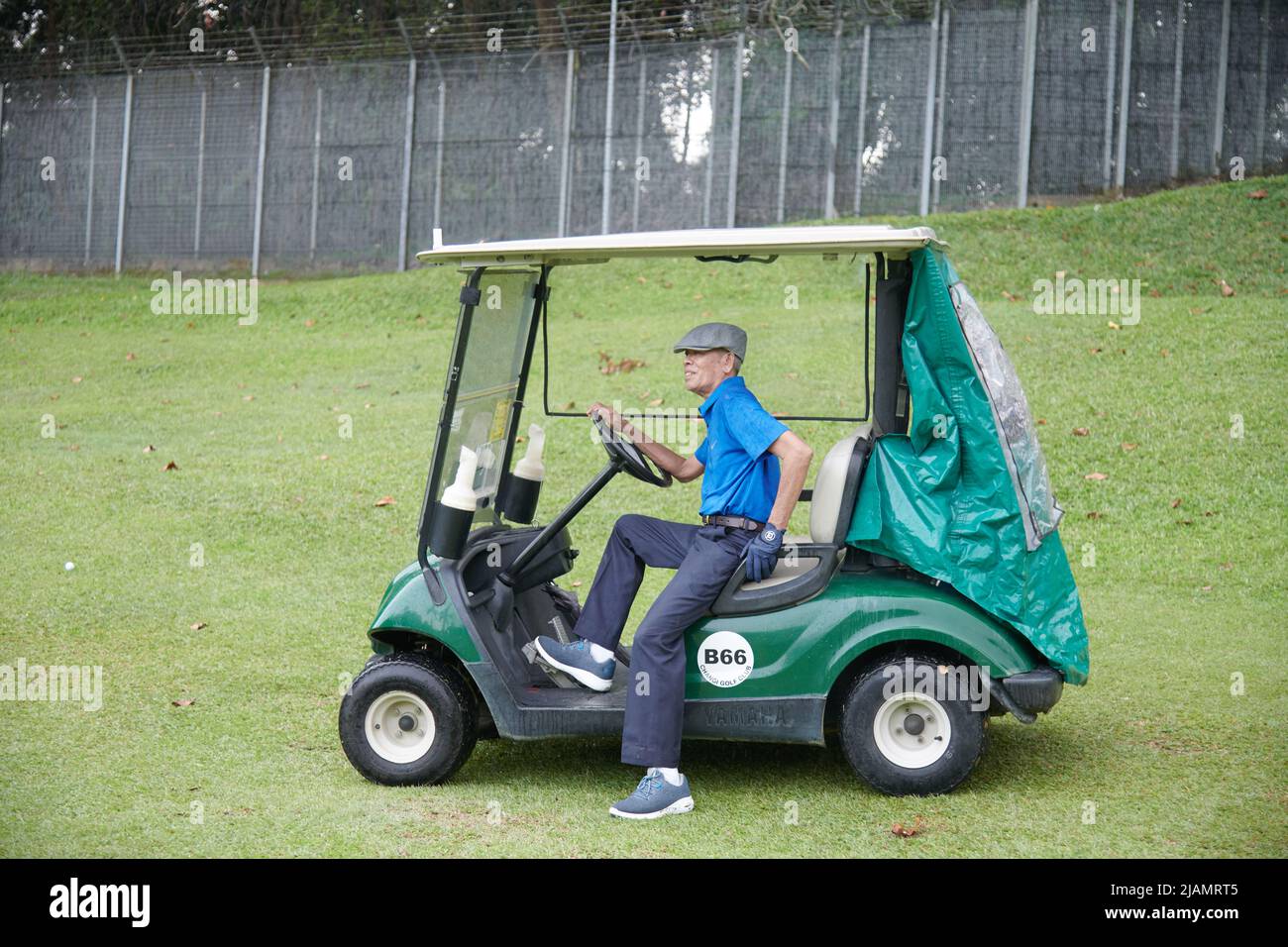 Father and son playing golf using a buggy to go around the course Stock ...