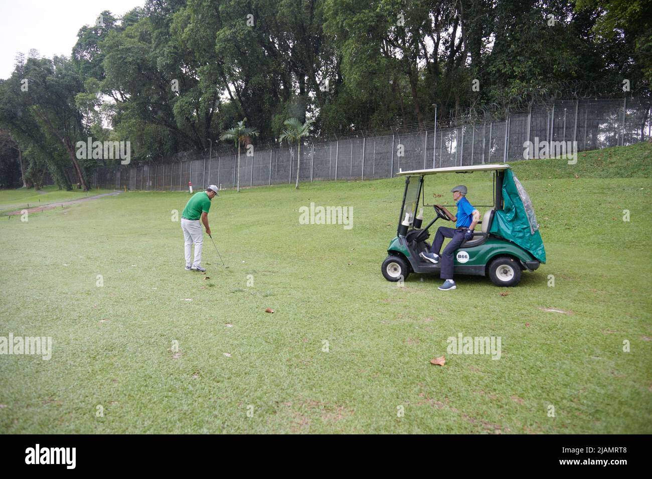 Father and son playing golf using a buggy to go around the course Stock ...