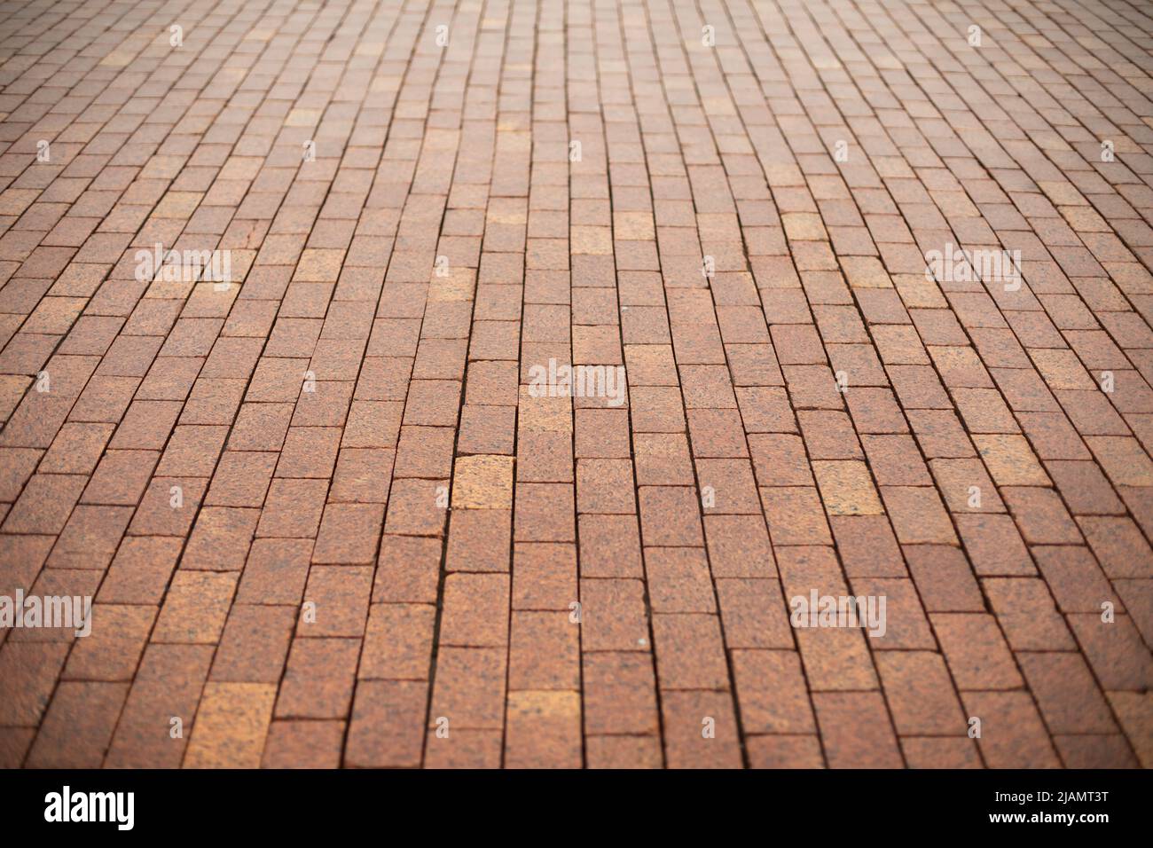 Stonework made of red cobblestones. Details of road. Tiles are laid in ...