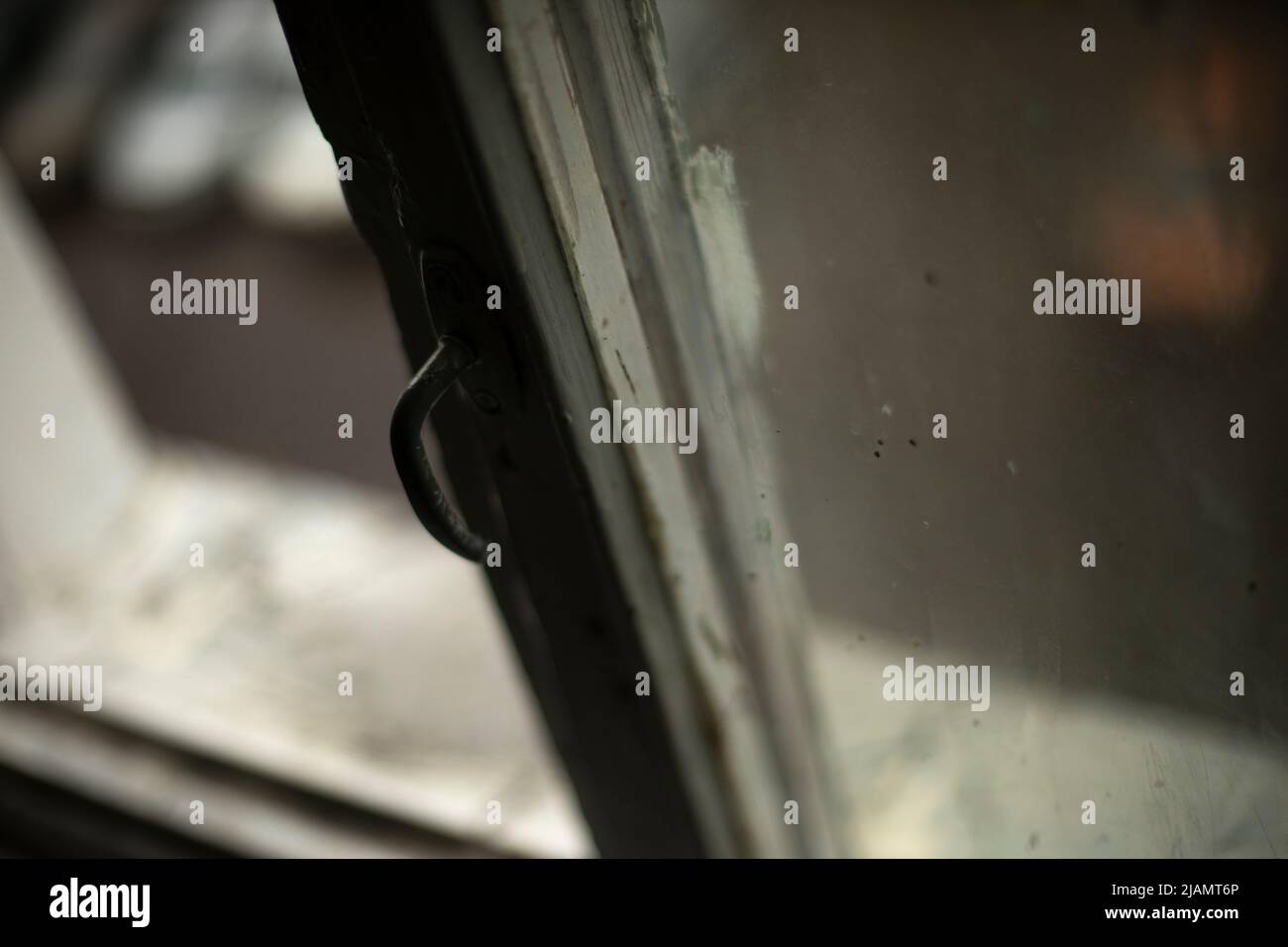 Old window. Wooden frame and glass. Interior details. Dirty glass in ...