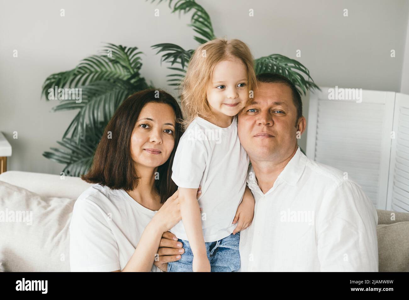 Happy family of three at home Stock Photo - Alamy