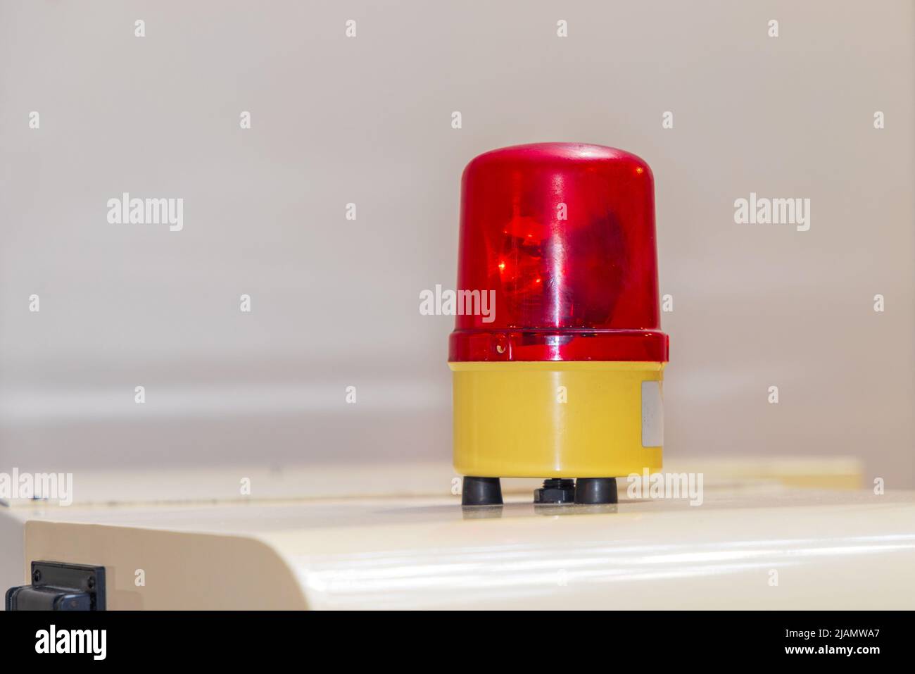 Red Dome Caution Rotating Light at Top of Machine Stock Photo - Alamy