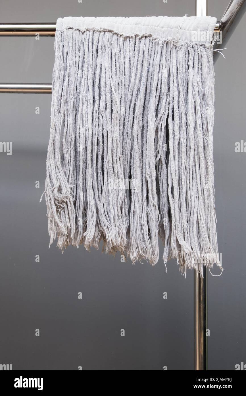 The dry mops were dried on the stainless steel clothesline beside the ...