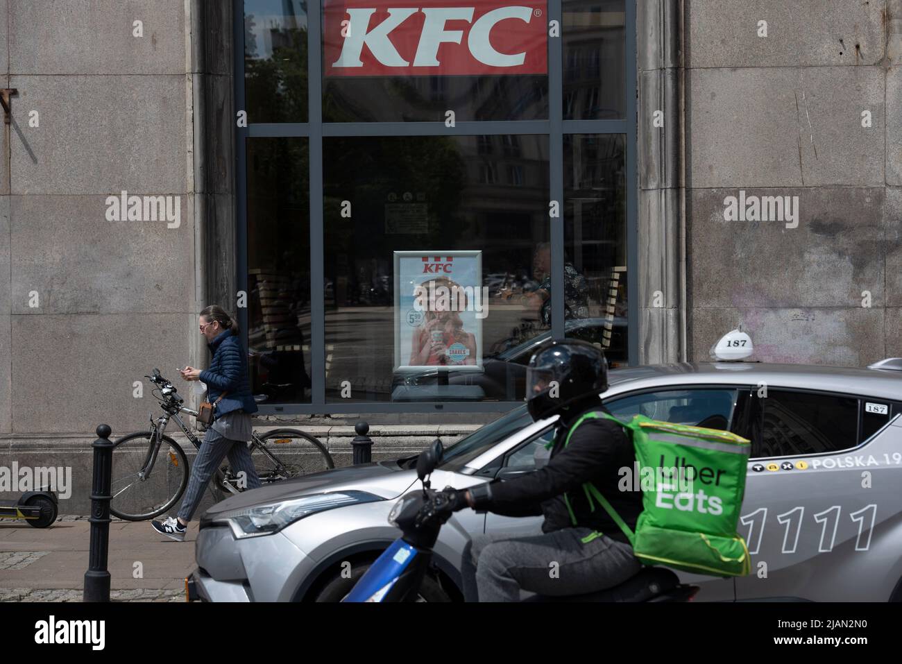 May 31, 2022, Warsaw, Warsaw, Poland: A Uber delivery man drives past a ...