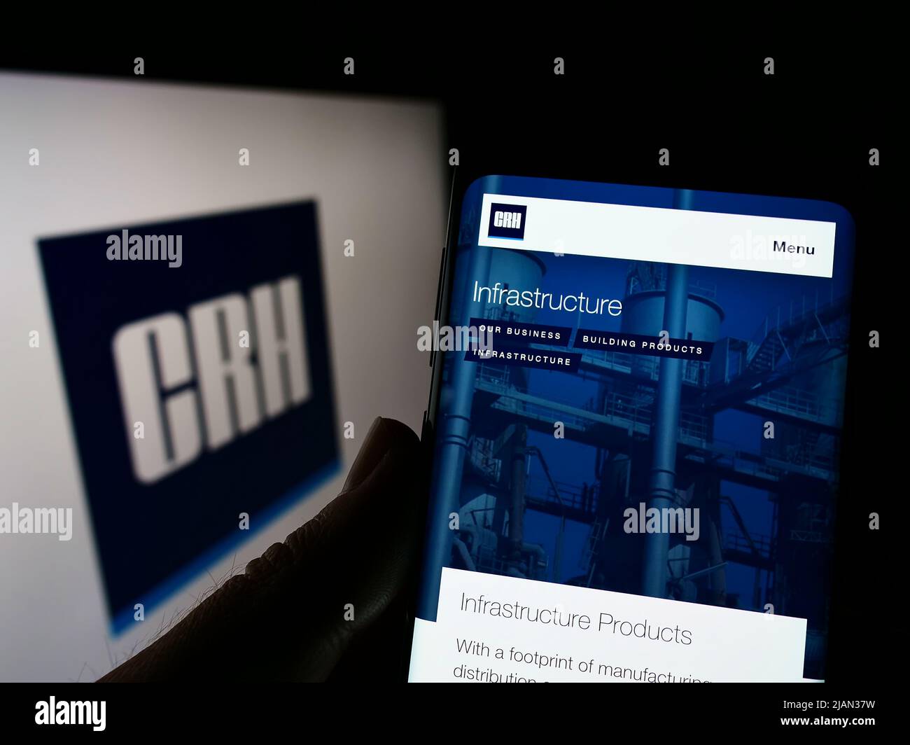 Person holding smartphone with webpage of Irish building materials ...