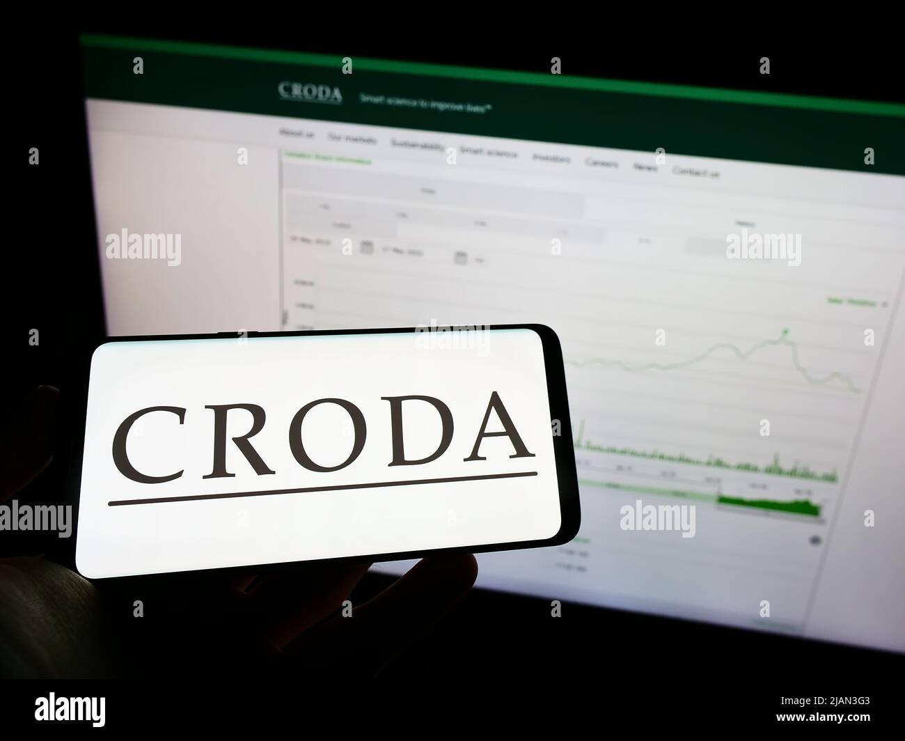 Person holding mobile phone with logo of chamicals company Croda ...