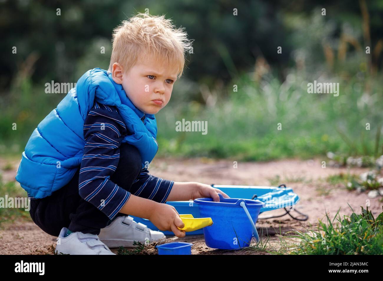 Three year old boy play with sand. Summer outdoor activity for kids ...
