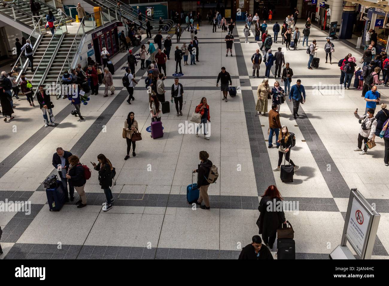 Commuters walk at a landmark Liverpool Street train station in London ...