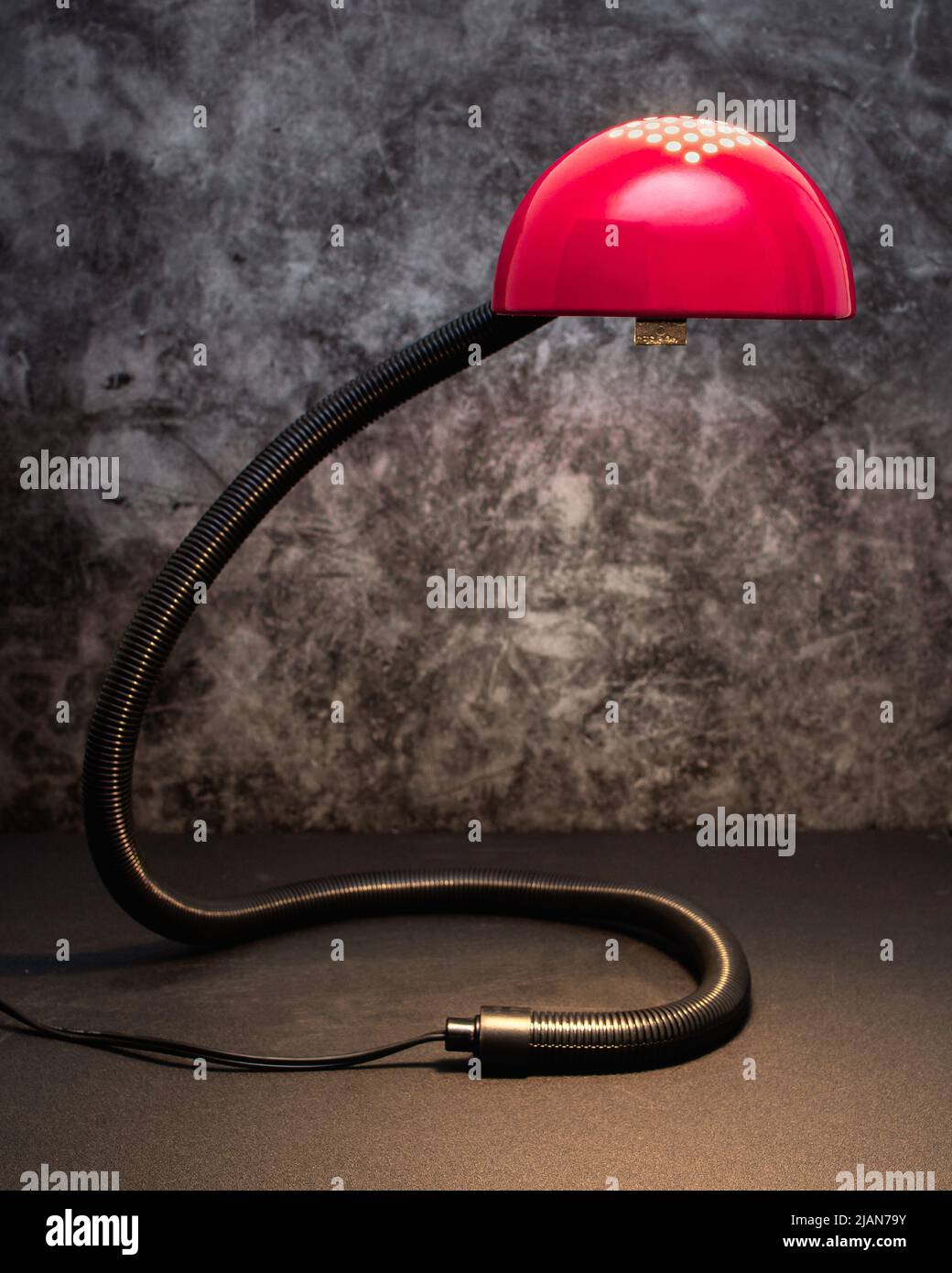 Red and black adjustable student type desk lamp Stock Photo - Alamy